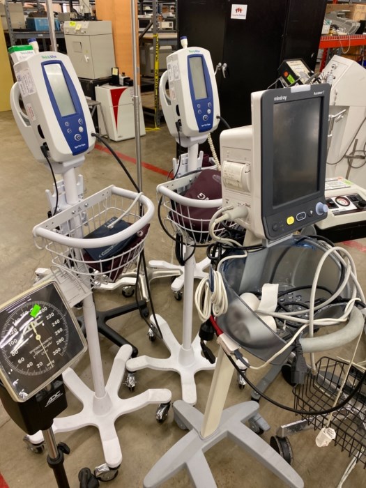 Huge lot of IV poles vital sign machines and more on casters for sale