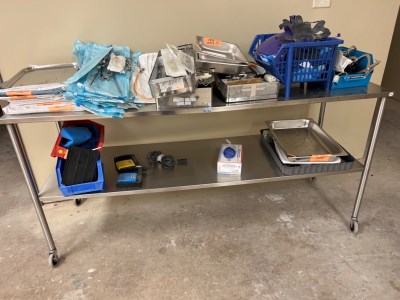 Large assortment of stainless steel trays, surgical tools, sterilizer ...