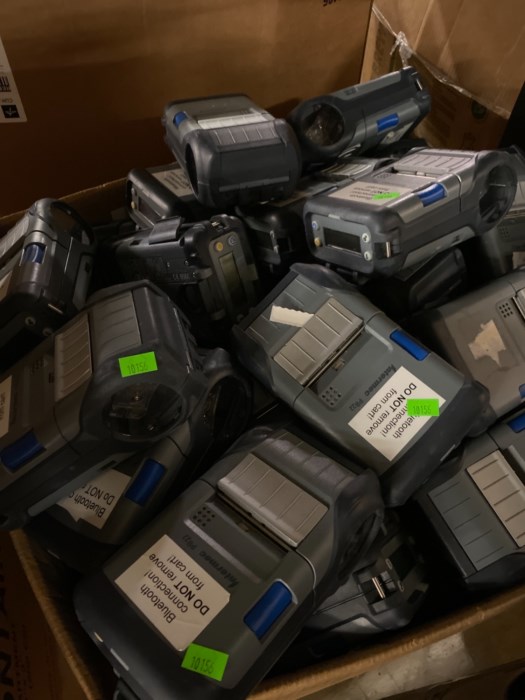 One aisle of random electronics including projectors for sale